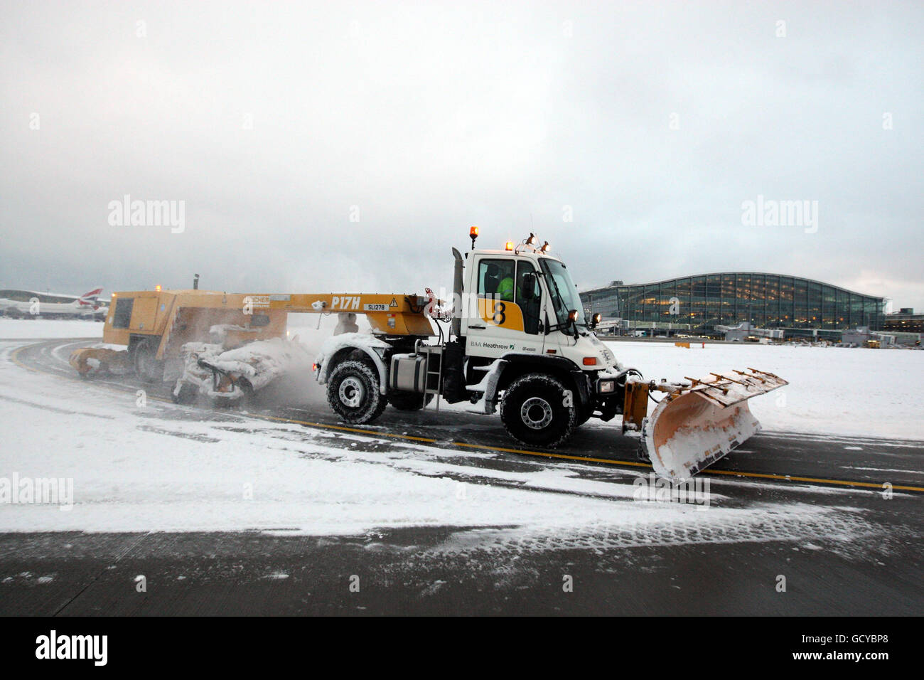 Snow ploughs clear the taxi ways at Heathrow Airport after heavy ...