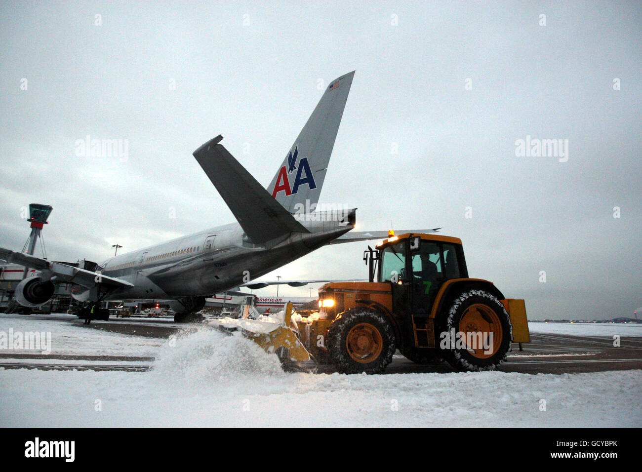 Snow ploughs clear the taxi ways at Heathrow Airport after heavy ...