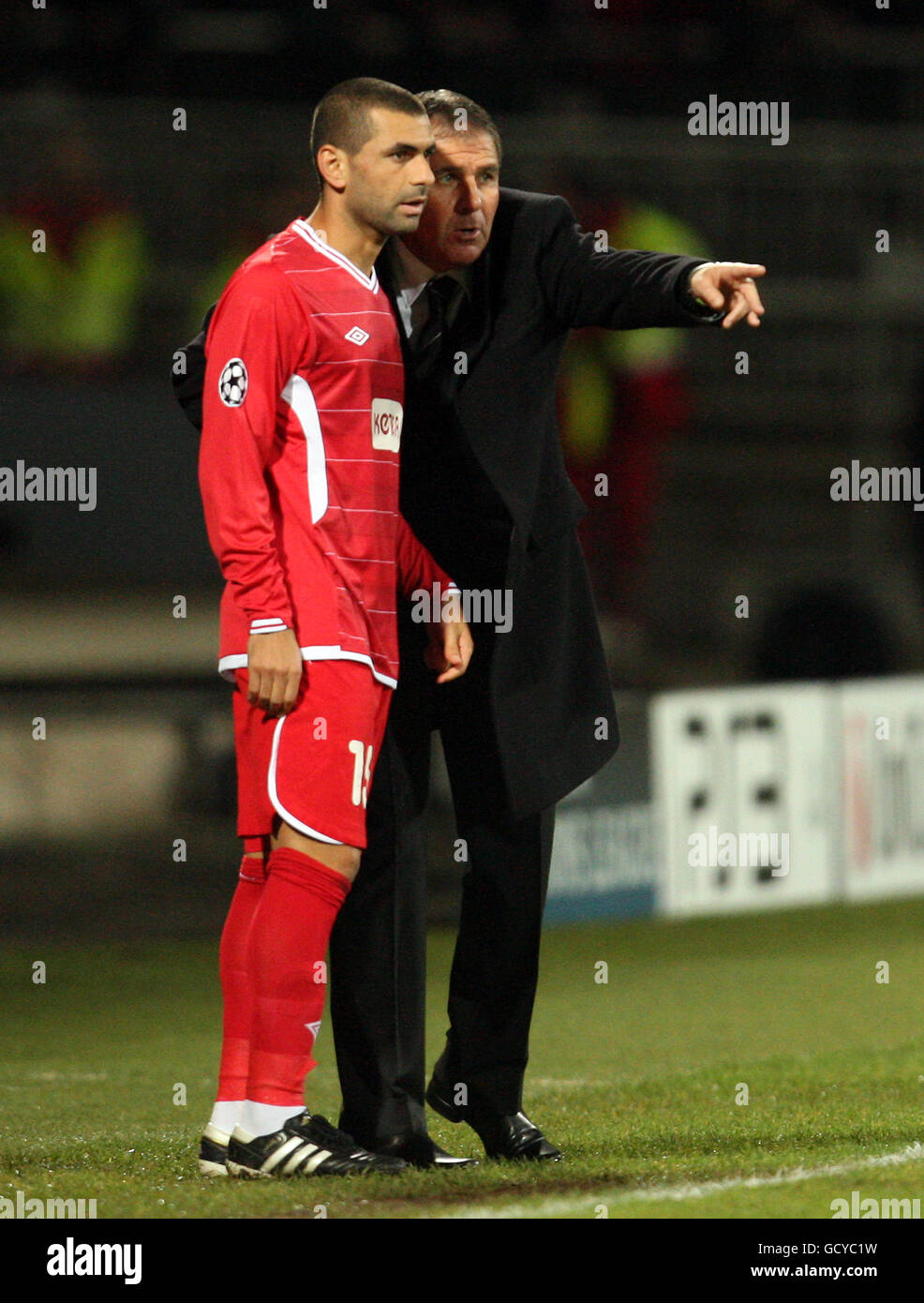 Hapoel Tel Aviv coach Eli Gutman gives instructions to Salim Toama ...