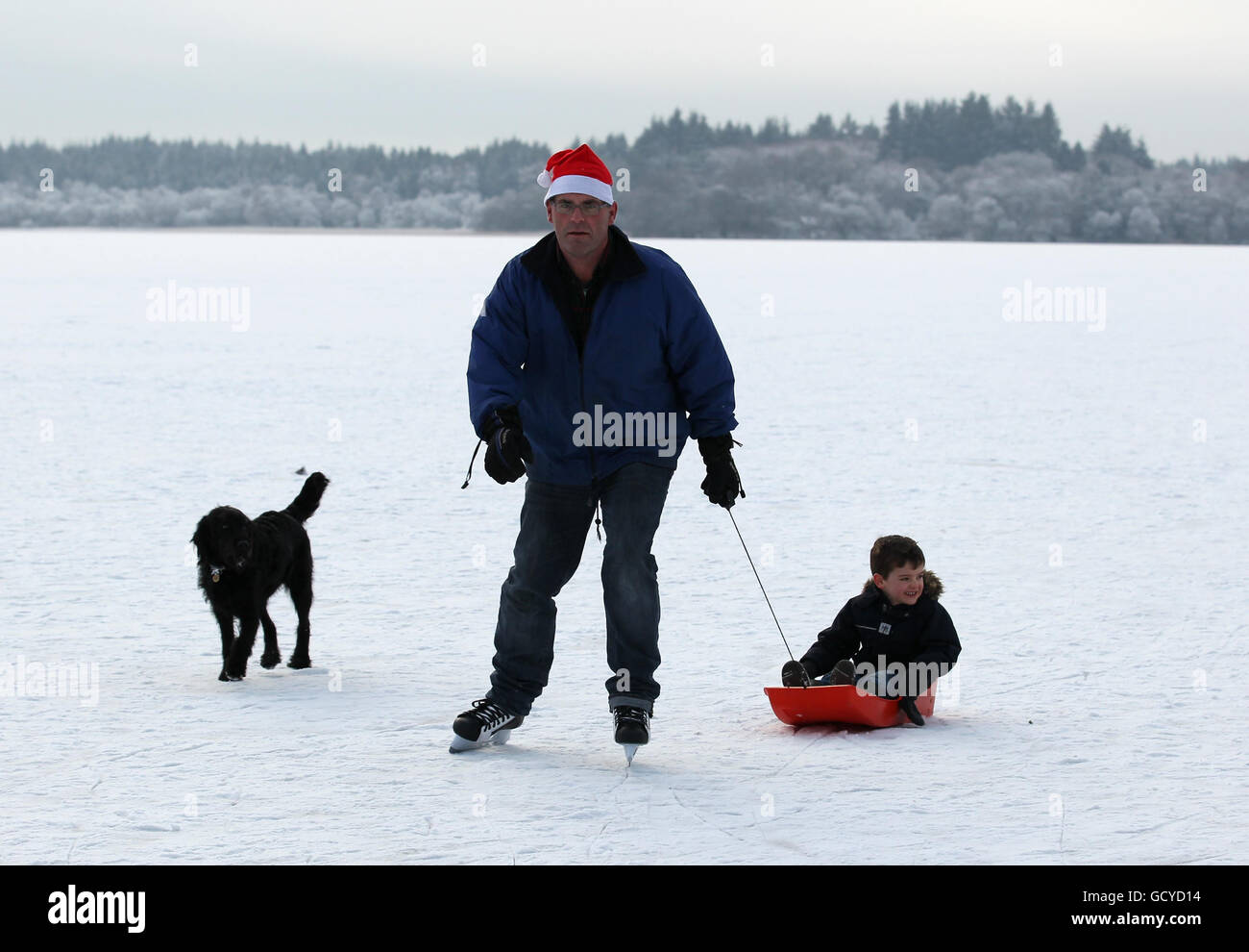 Mark Saunders with son Charlie and dog Madge on a frozen Lake of ...