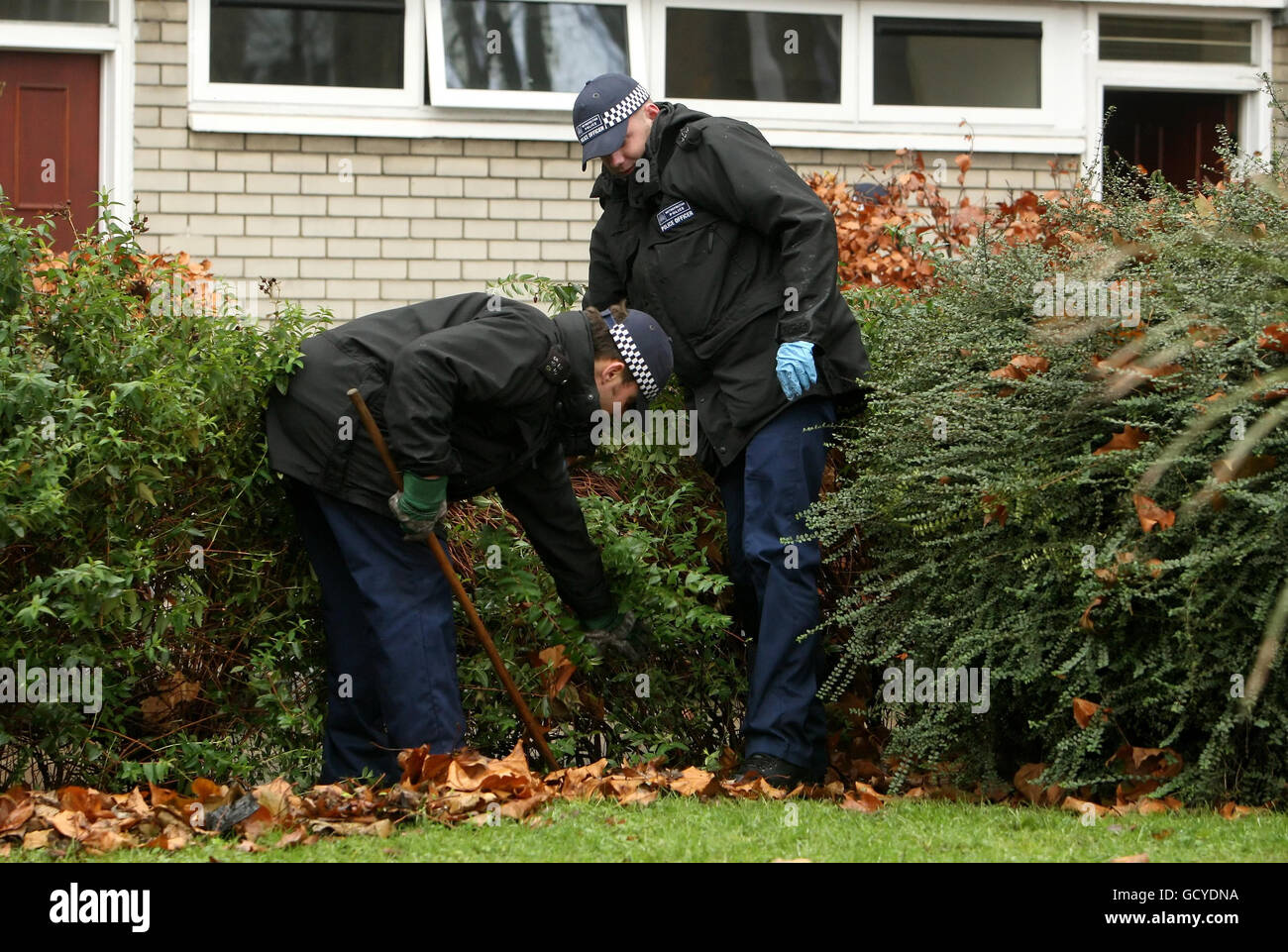 Police search bushes at Heron House, on the Pelican Estate, in Peckham ...