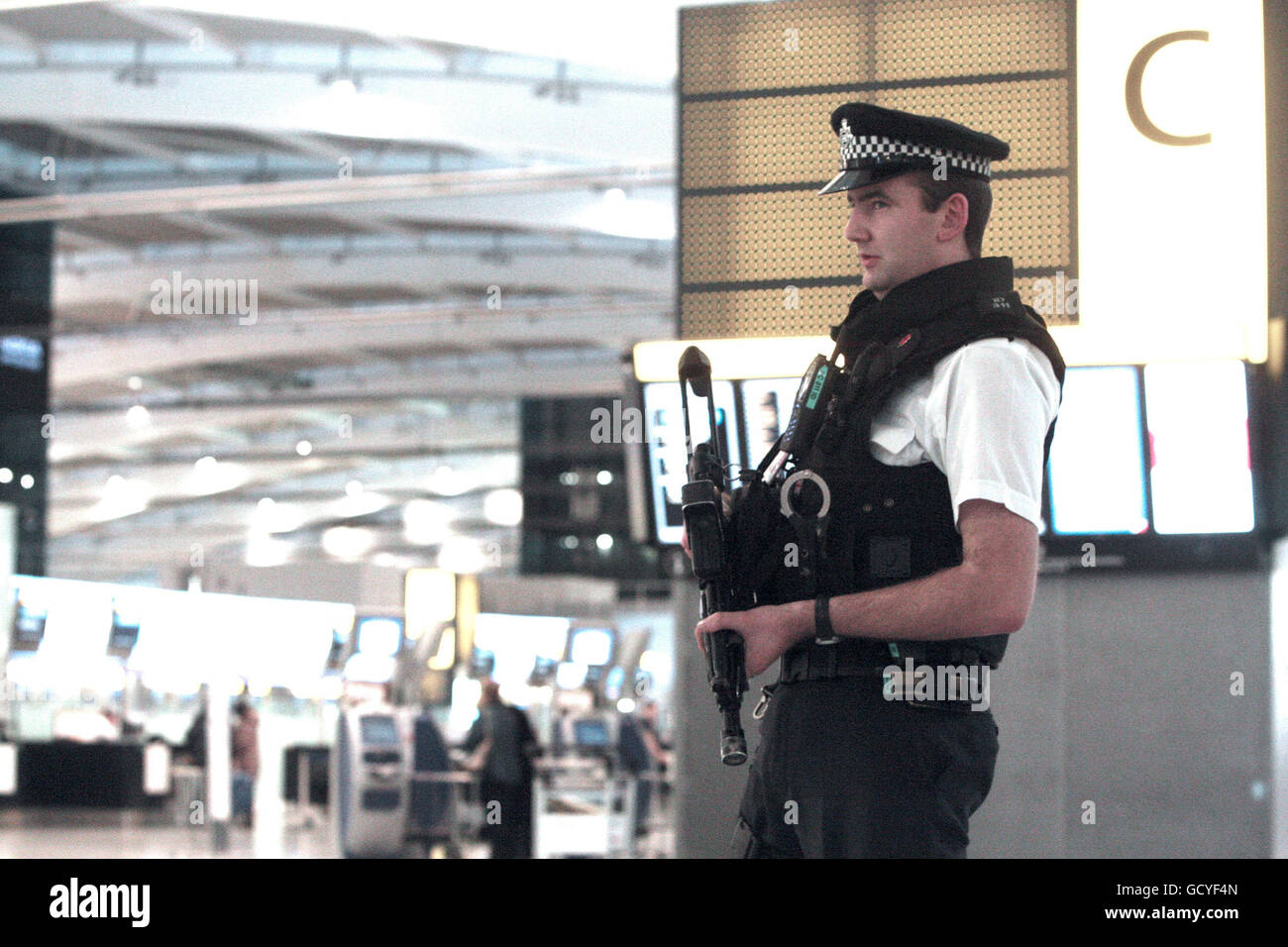 An armed police officer on patrol at Heathrow Airport's Terminal 5, as ...