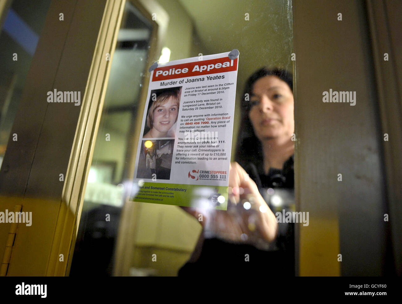 A police detective places a poster in the window of the Bristol Ram pub ...