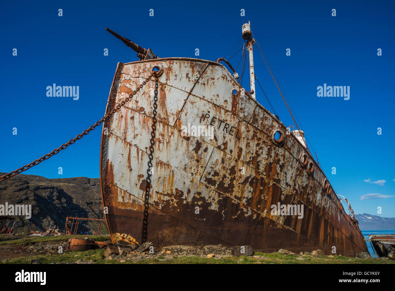 Rusty old whaler chained up beside dock; Antarctica Stock Photo - Alamy