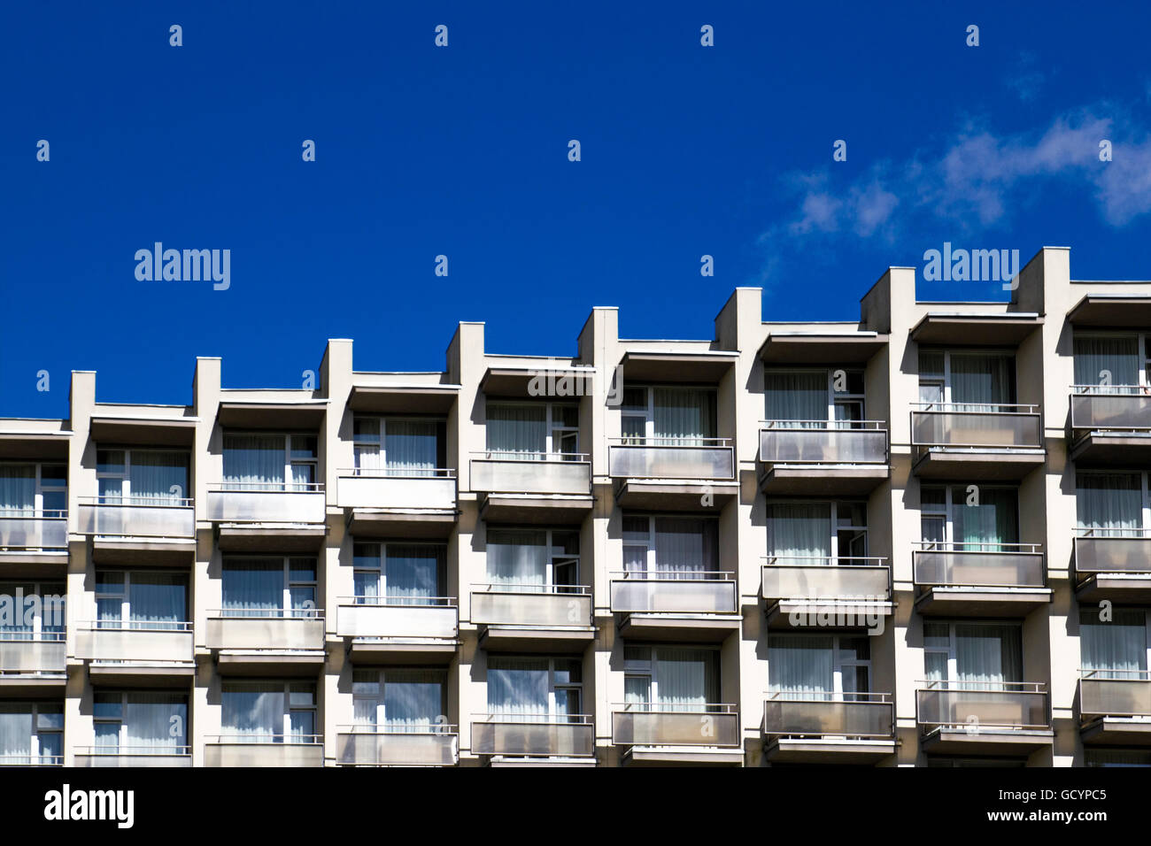 Modern building front wall with repeating pattern of windows and ...