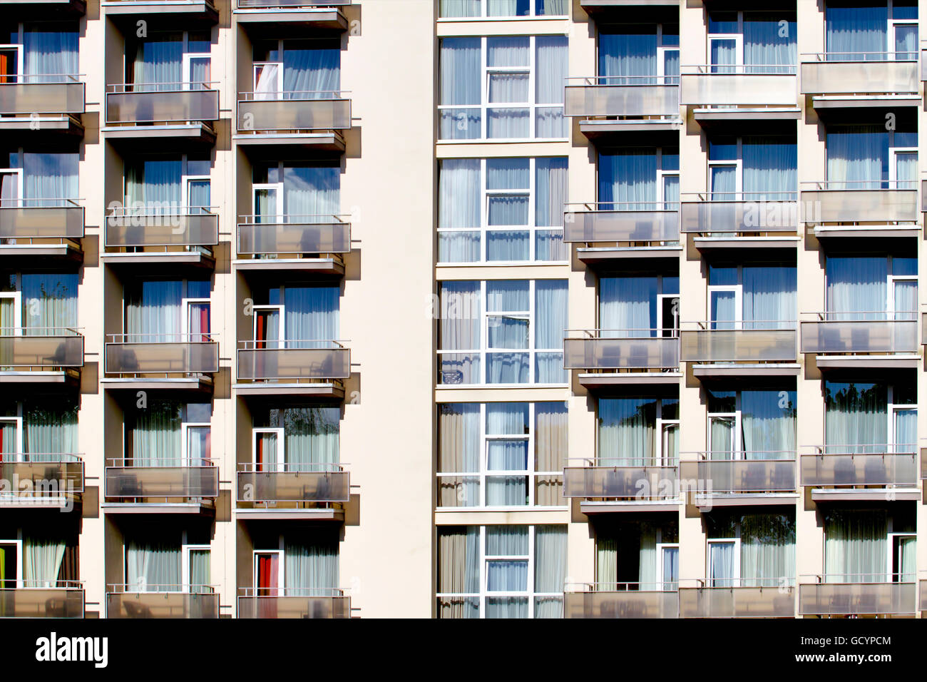 Modern building front wall with repeating pattern of windows and ...