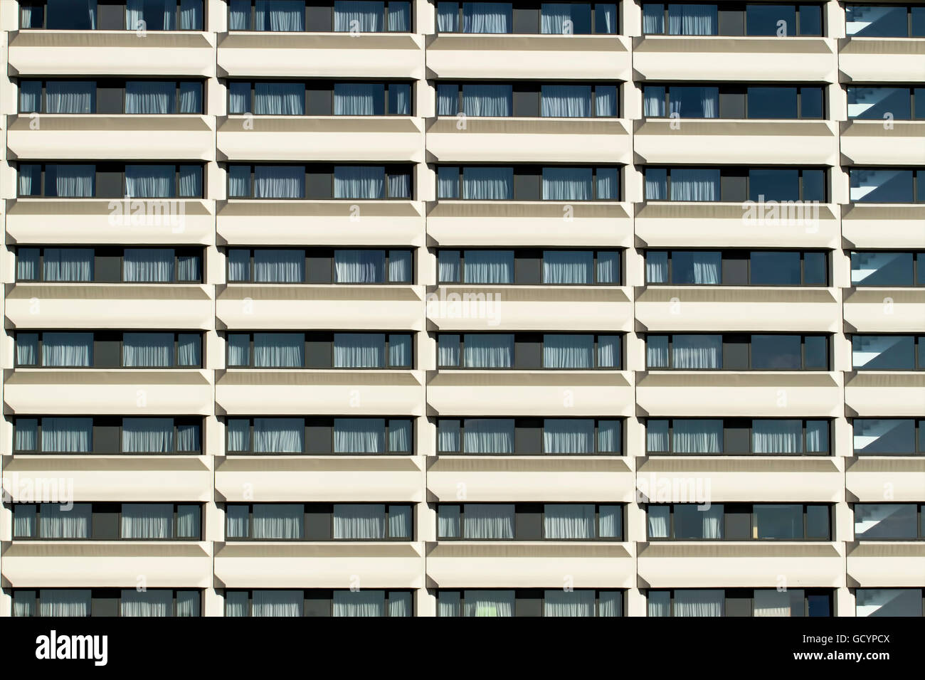 Modern building front wall with repeating pattern of windows. Close up ...