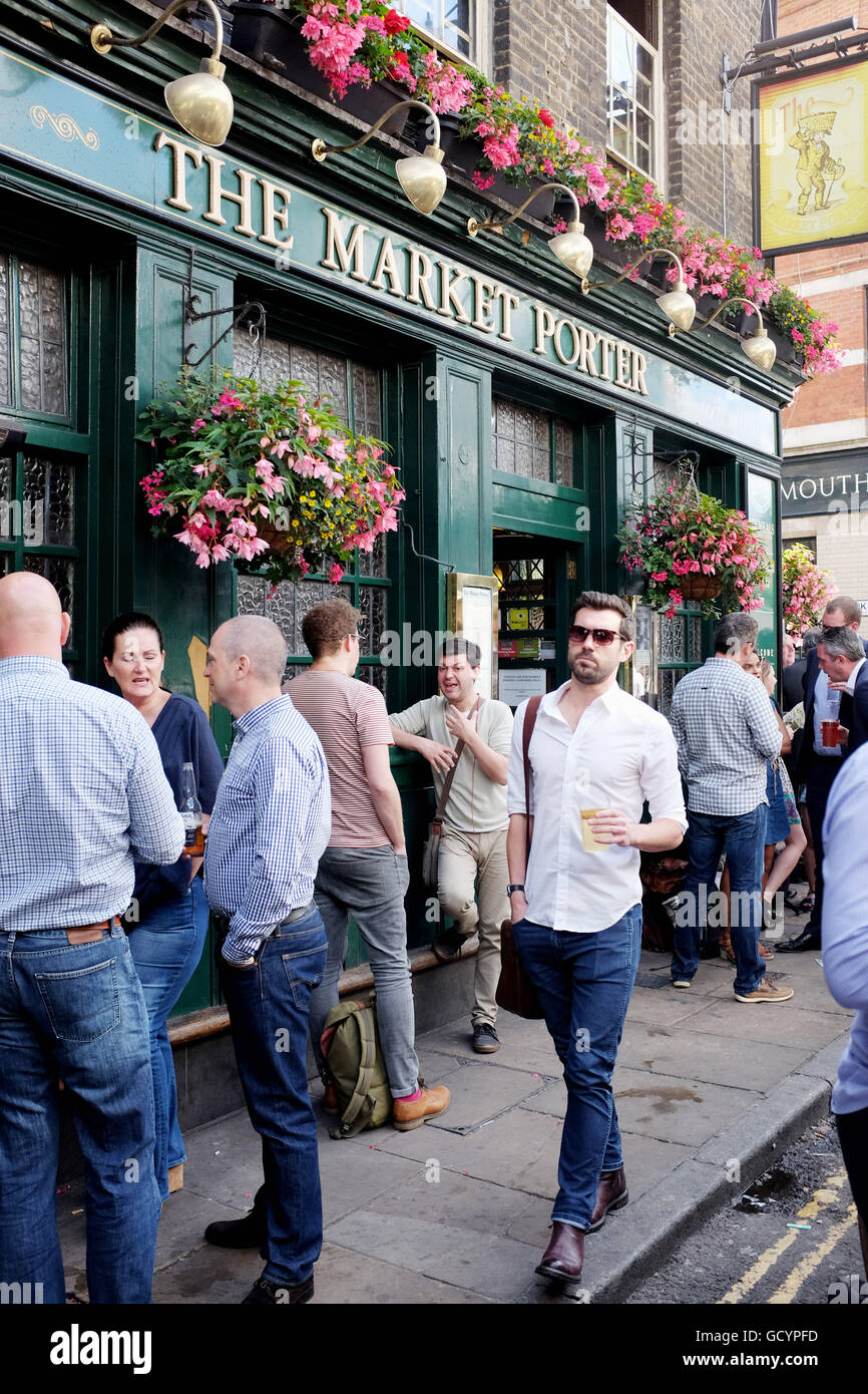 People drinking outside the Market Porter Pub in Borough Market London ...