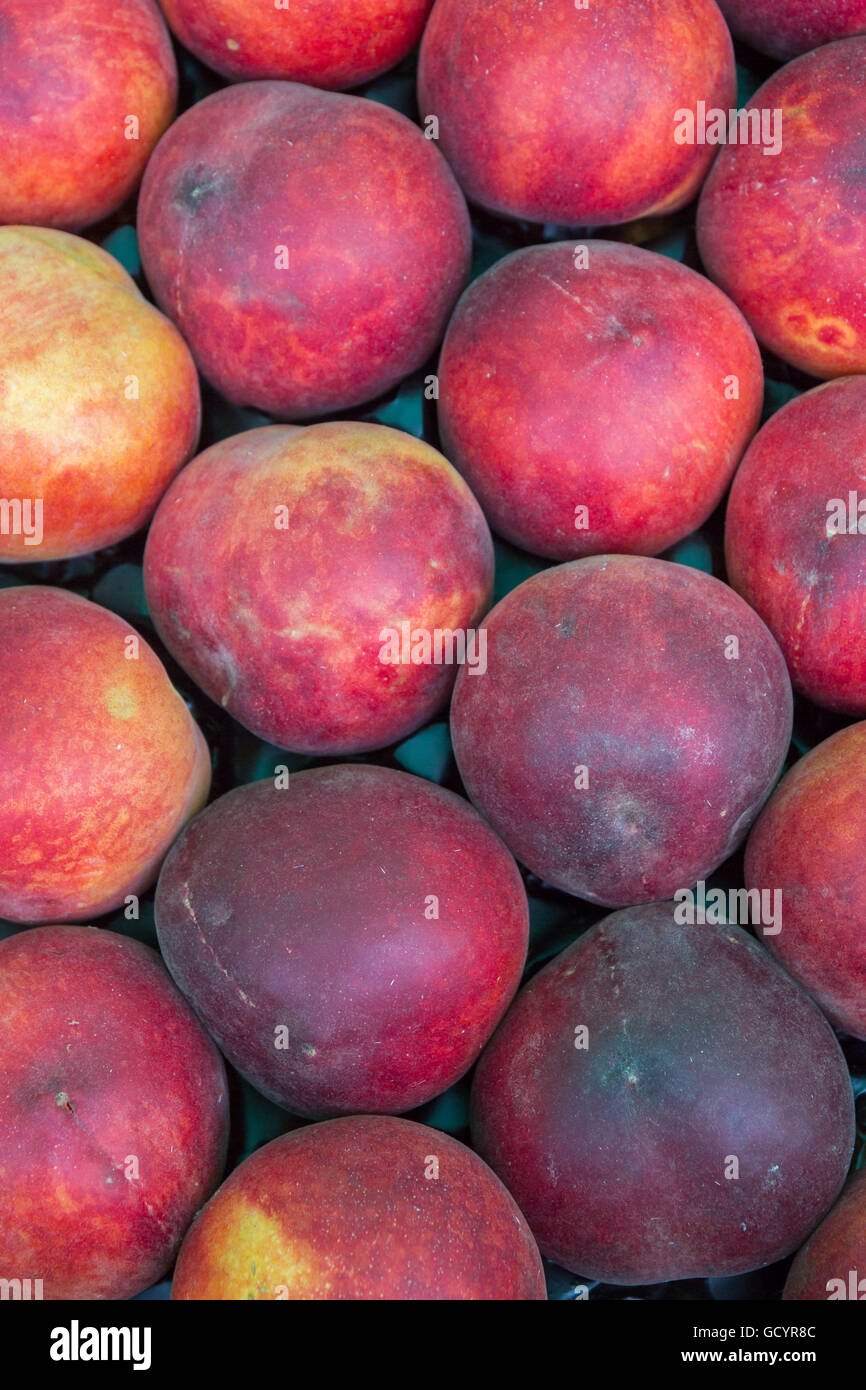 Delicious ripe fruit nectarine in the market on the counter Stock Photo ...