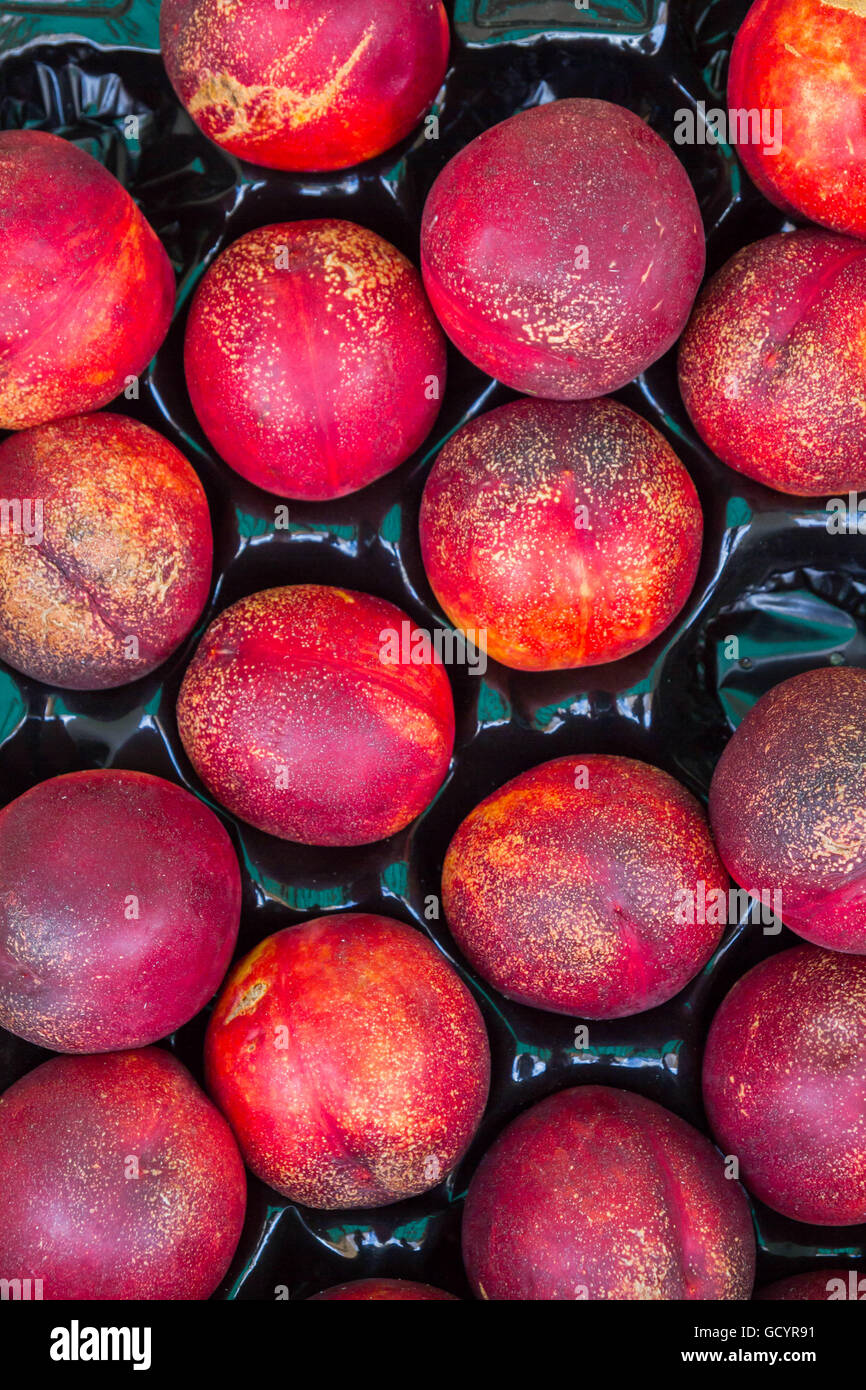 Delicious ripe fruit nectarine in the market on the counter Stock Photo ...