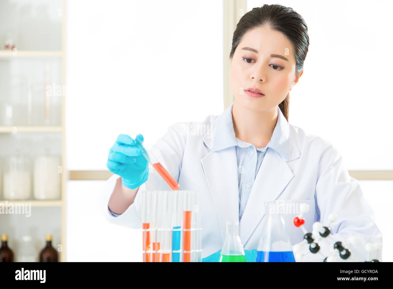 Asian female forensic scientist to find the answer, adjust her focus in ...