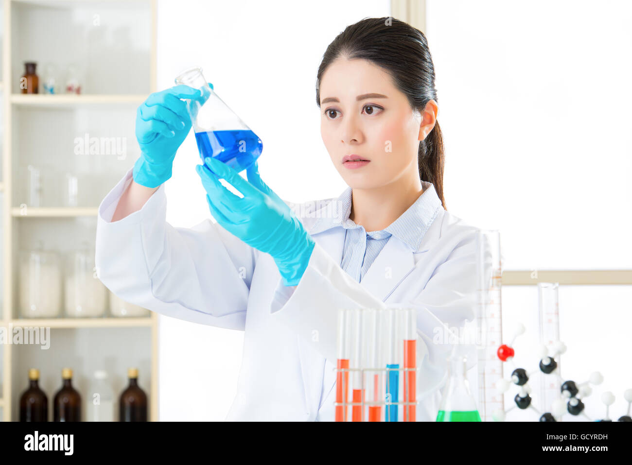 Asian female scientist know the cure answers are all in the details ...