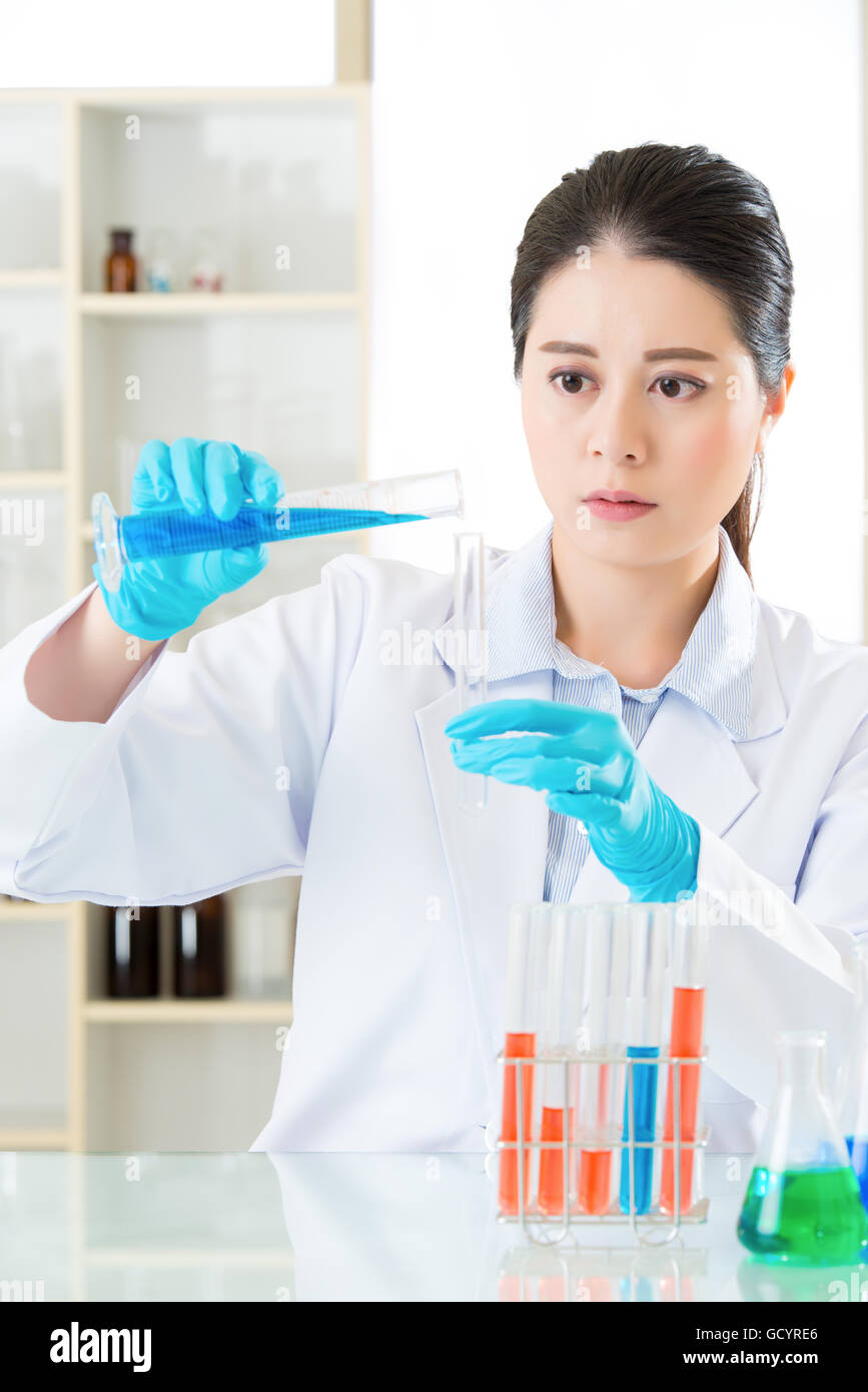 Asian female scientist chemistry researchers observing indicator color ...