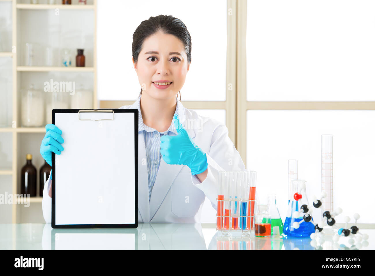 happy female scientist discover good result and thumb up with smile ...