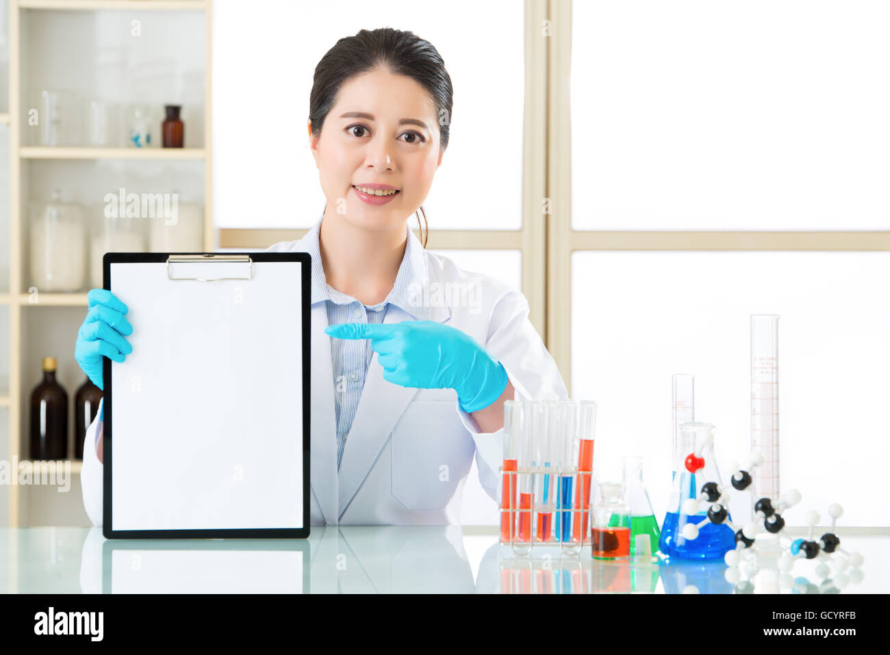 Asian female scientist point on her blank clipboard in laboratory Stock ...