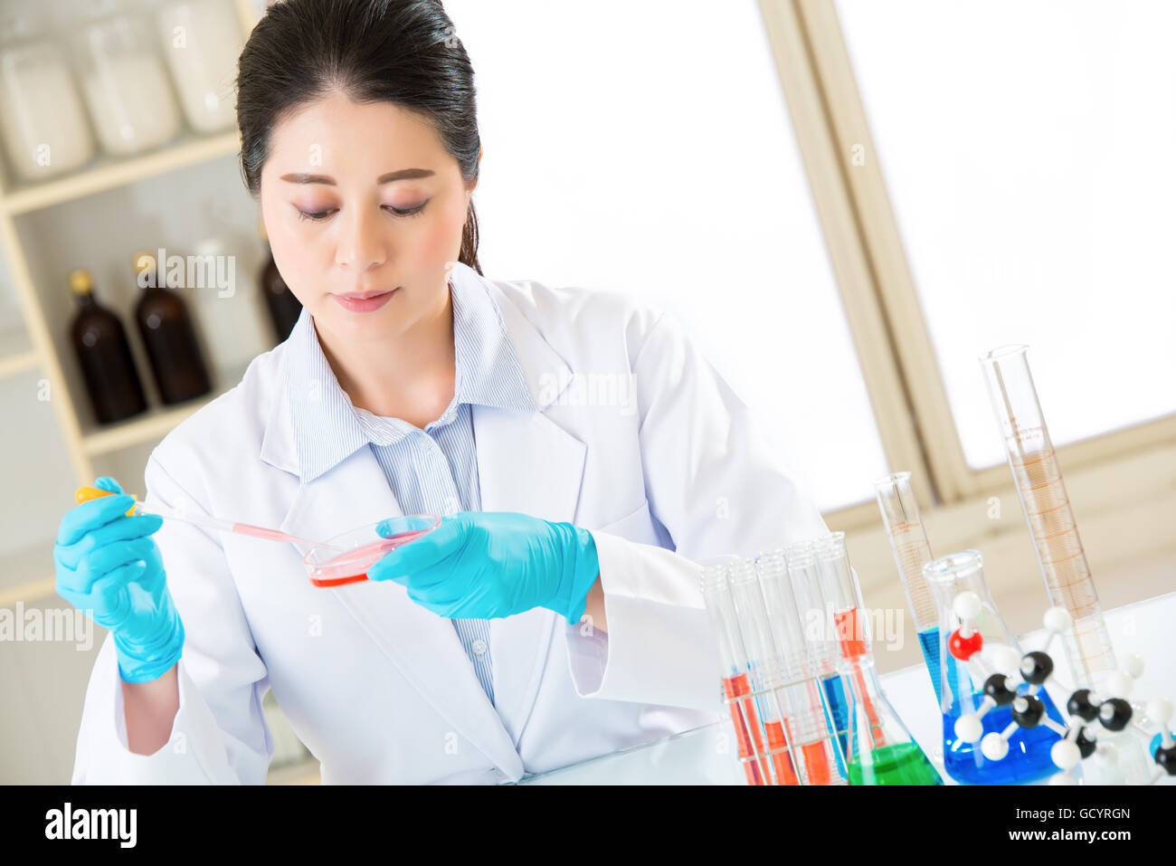 professional Young asian chemist working on chemical substances in ...
