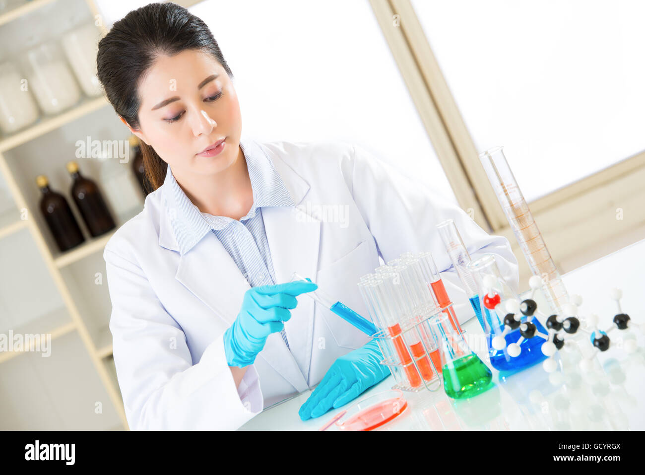 female scientist researcher observing indicator color shift in ...