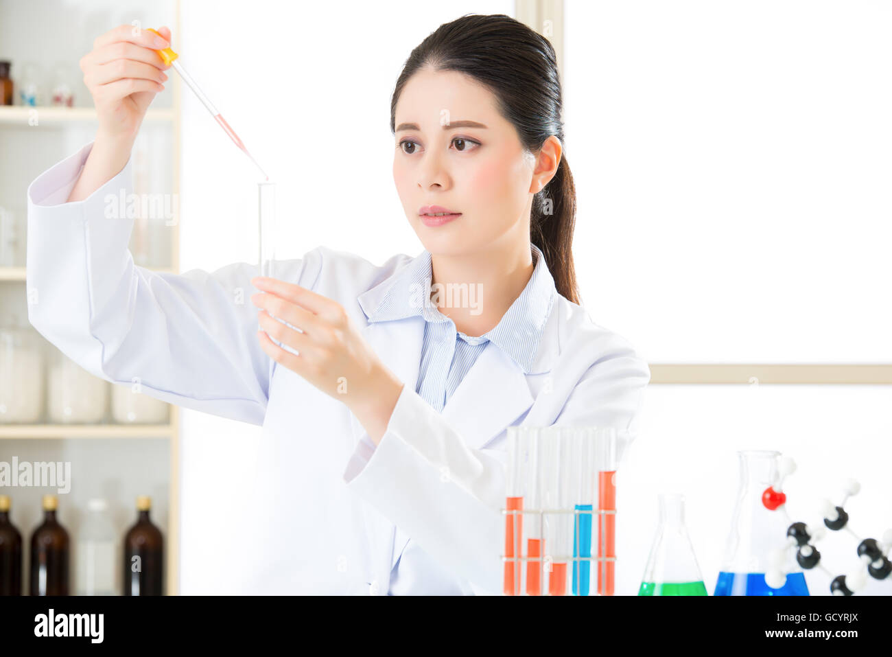 Careful, meticulous work of asian female scientist use dropper in ...