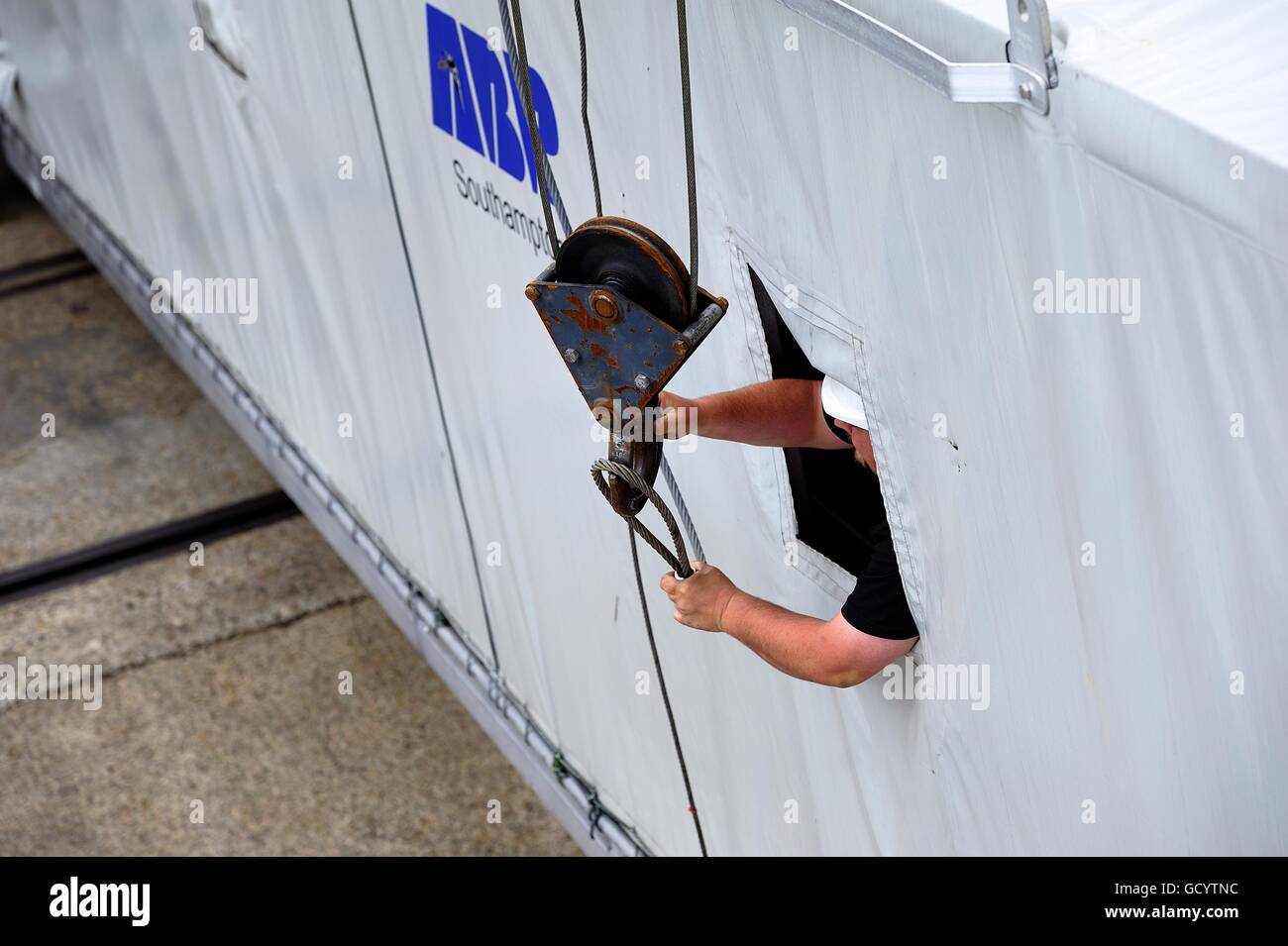 Hands fixing the rope to the hook Stock Photo - Alamy