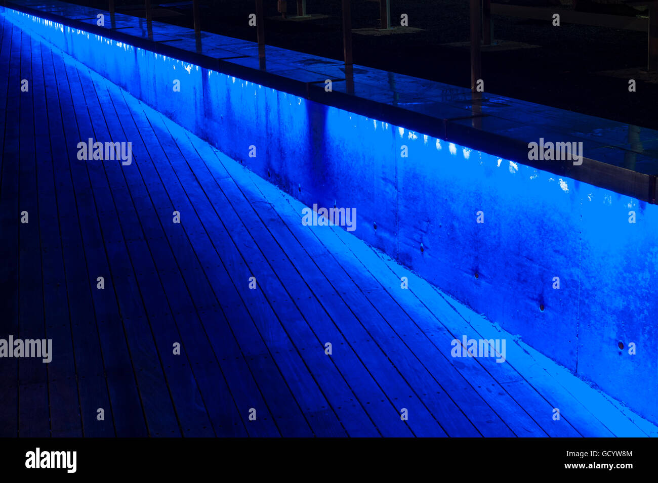 Downtown Seattle park at night with bright blue colors and cement wall ...
