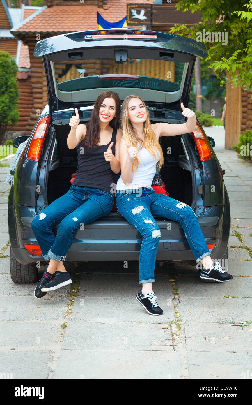Two girls posing in car Stock Photo - Alamy