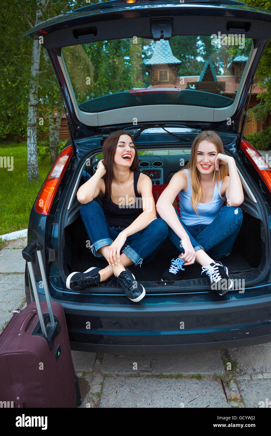 Two girls posing in car Stock Photo - Alamy