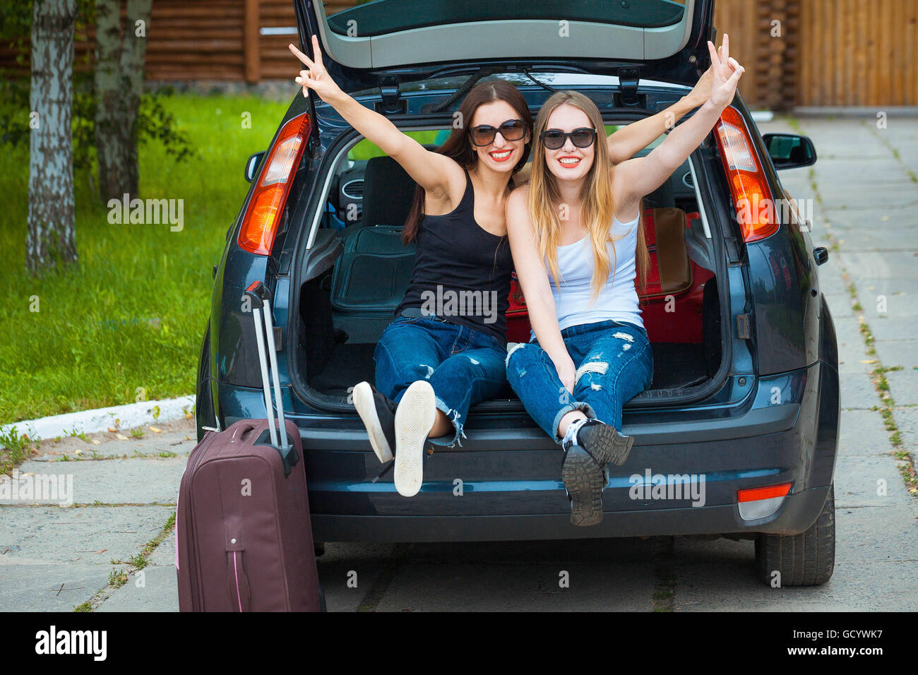 Two girls posing in car Stock Photo - Alamy