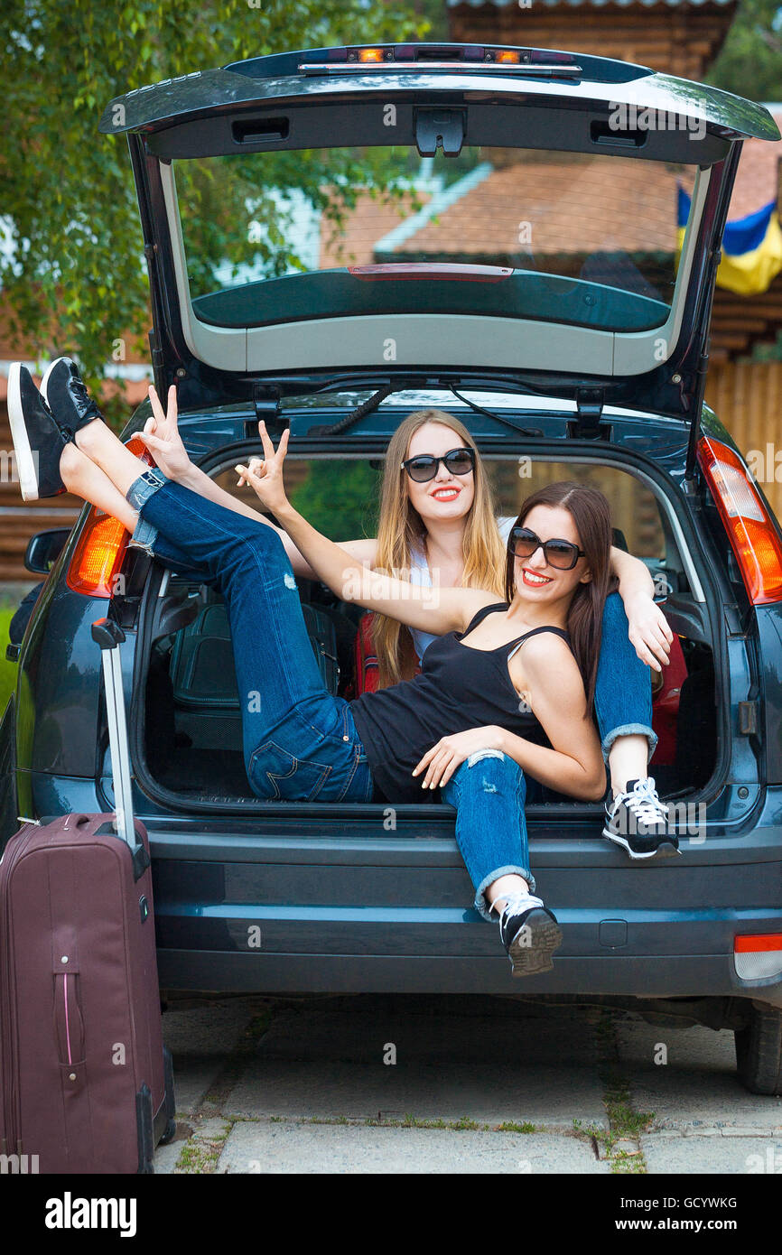 Two girls posing in car Stock Photo - Alamy