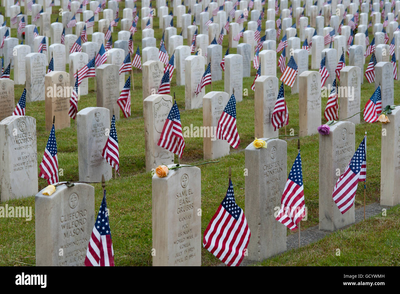 Memorial Day Ceremony at cemetery with American Flags at grave sites ...