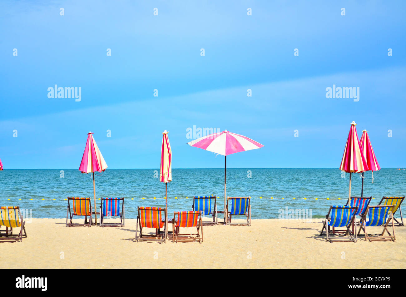 Chairs and umbellar on white sand beach Stock Photo - Alamy