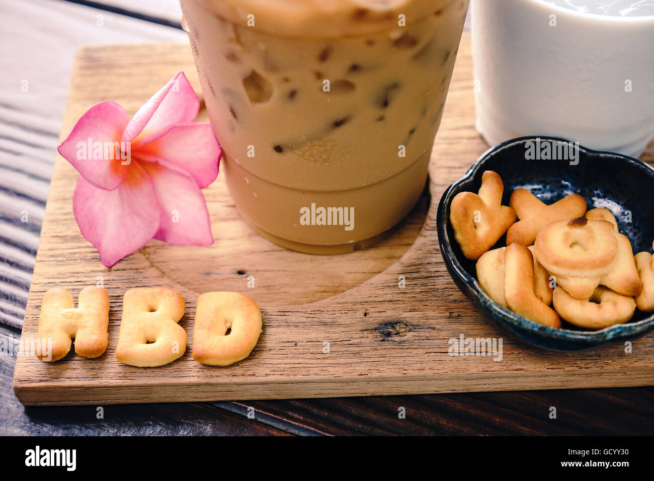 iced coffee and biscuit alphabet spell HBD with rice field background ...