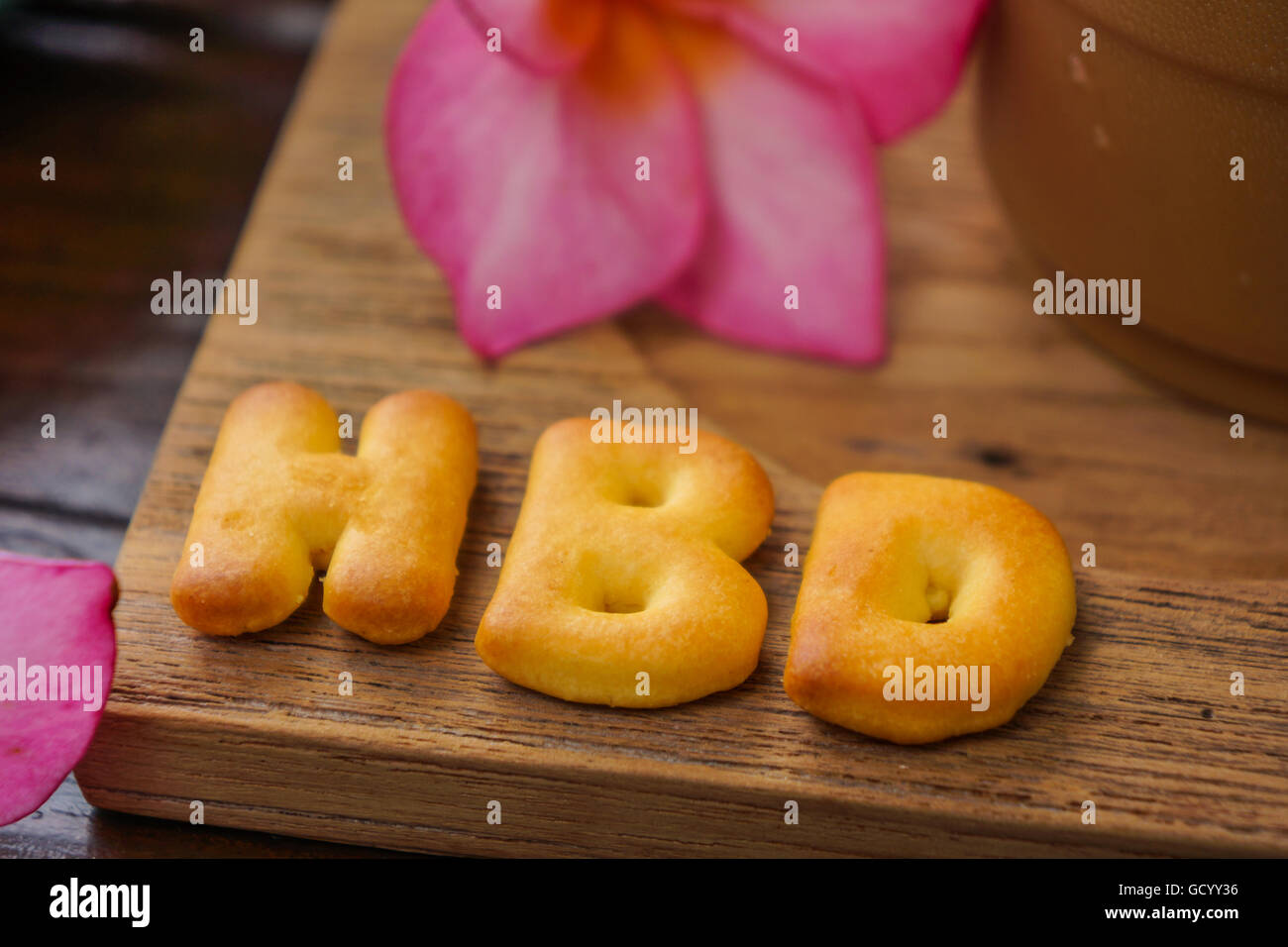 iced coffee and biscuit alphabet spell HBD with rice field background ...