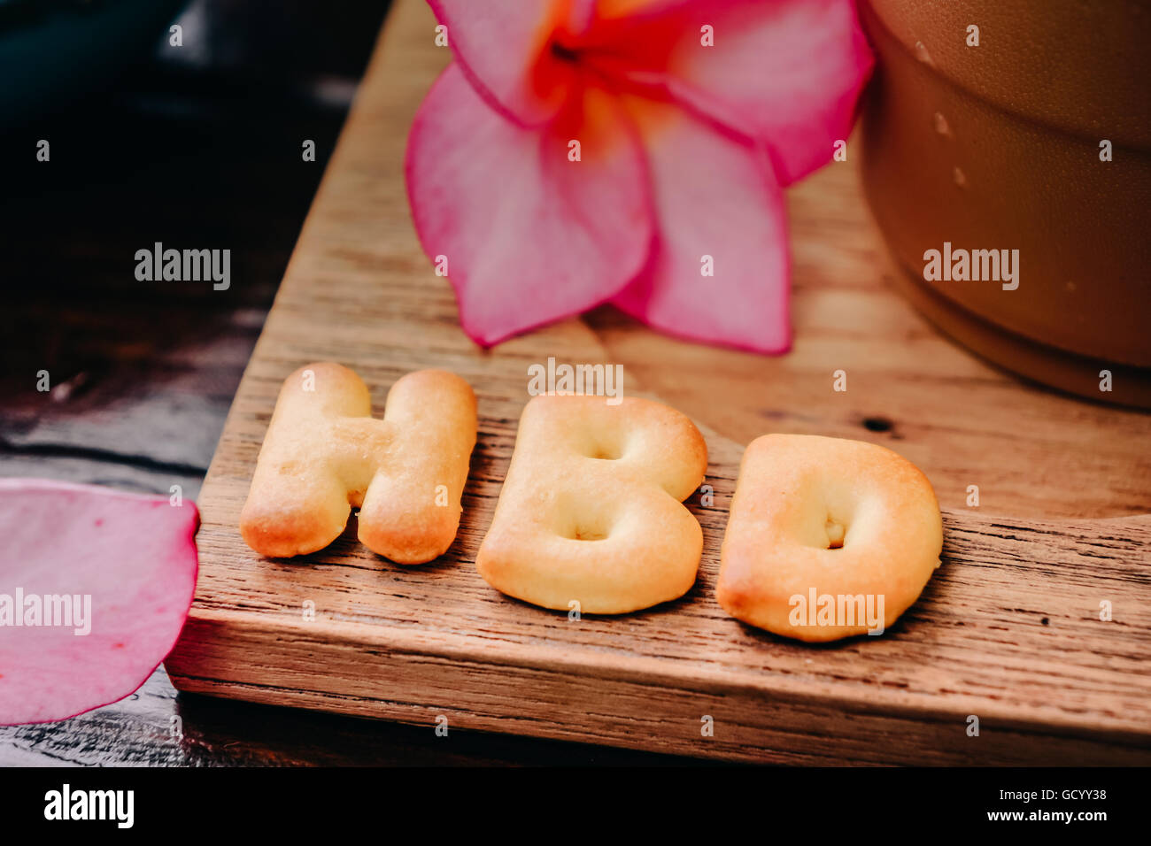 iced coffee and biscuit alphabet spell HBD with rice field background ...