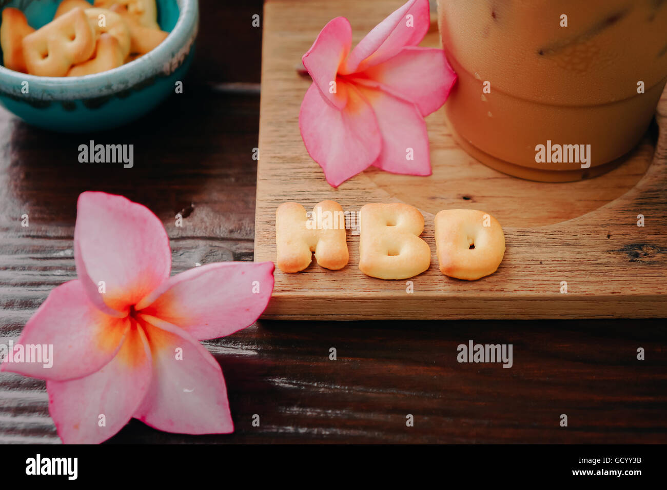 iced coffee and biscuit alphabet spell HBD with rice field background ...