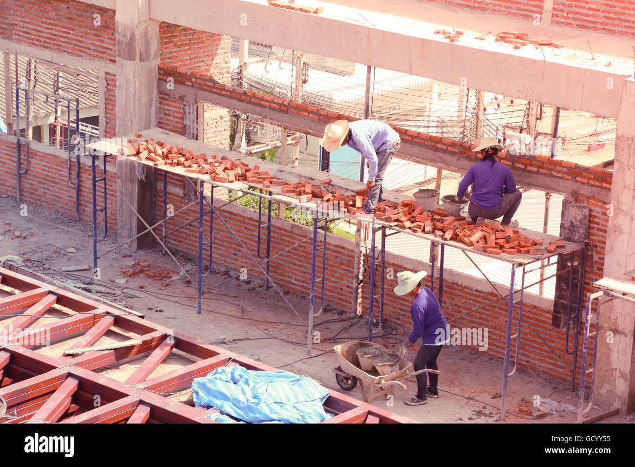 building under construction with workers Stock Photo - Alamy