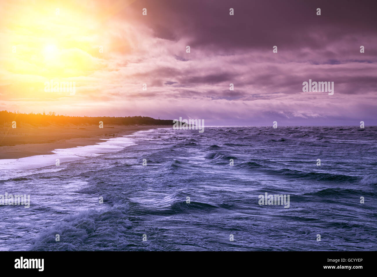 Sunset over stormy sea Stock Photo - Alamy