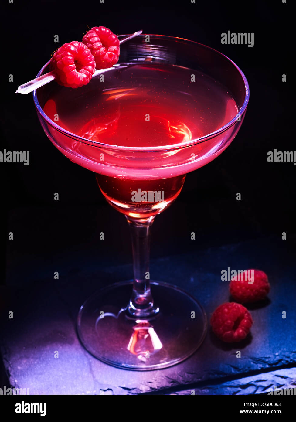 Raspberry martini cocktail on black background Stock Photo - Alamy
