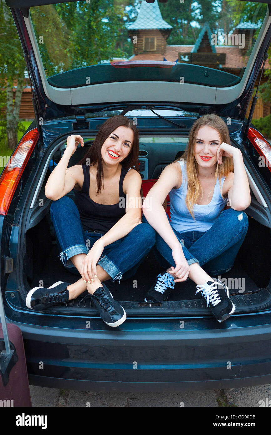 Two girls posing in car Stock Photo - Alamy