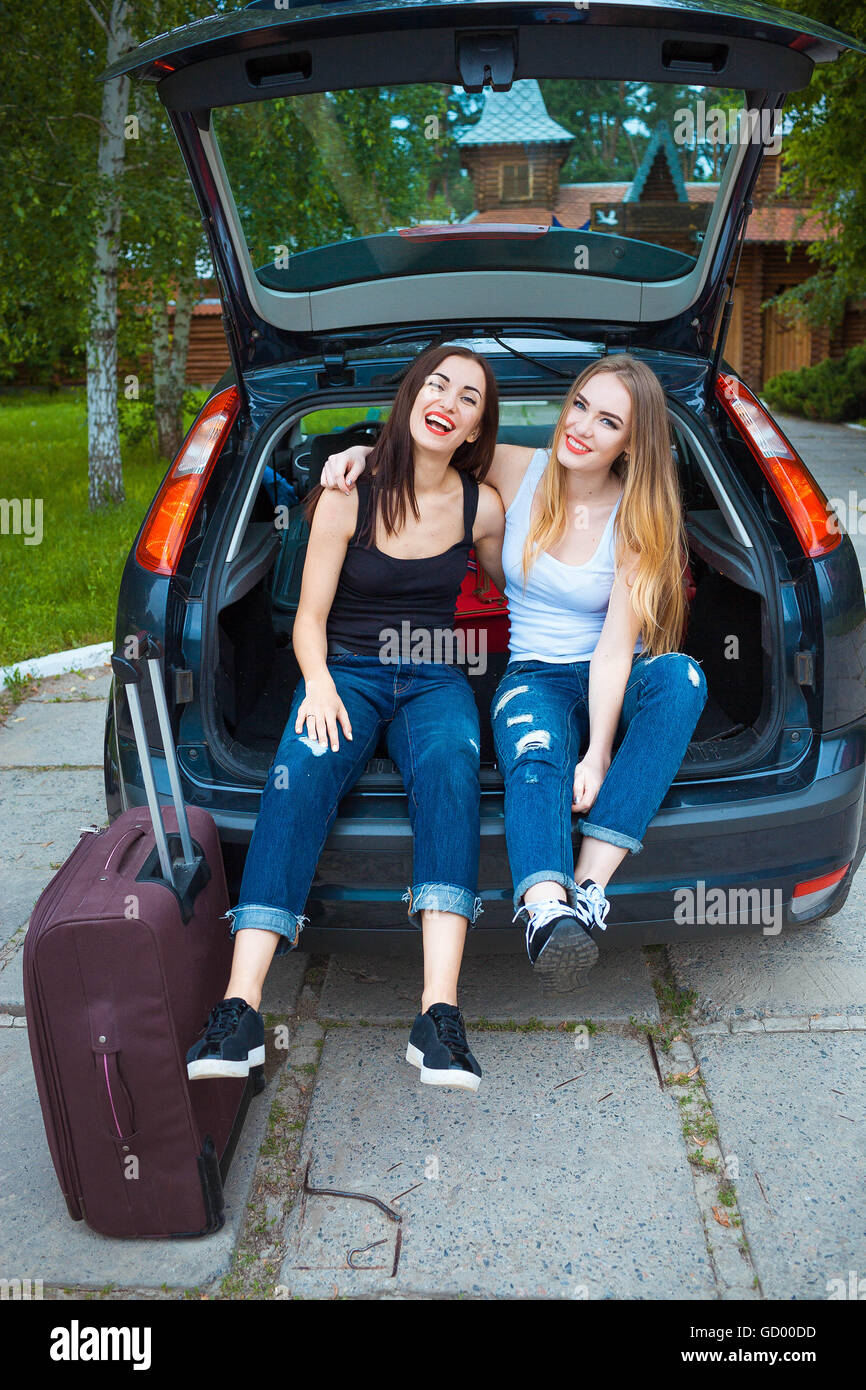 Two girls posing in car Stock Photo - Alamy