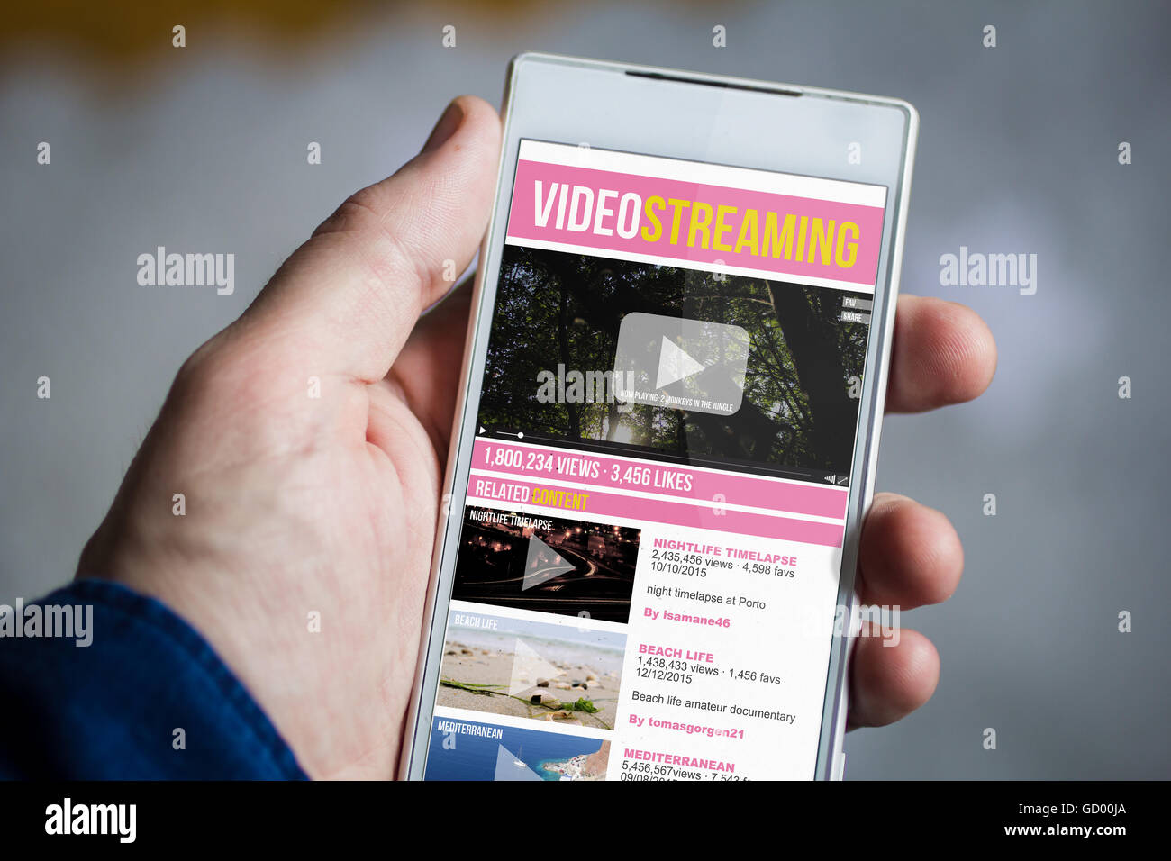 man hand holding video streaming smartphone. All screen graphics are ...