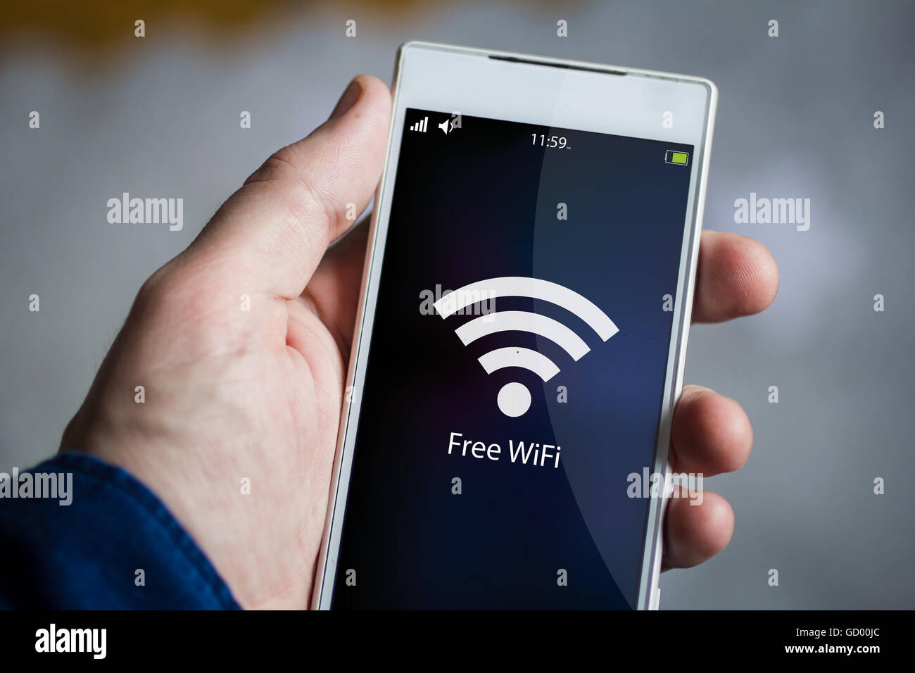 man hand holding free wifi smartphone. All screen graphics are made up ...