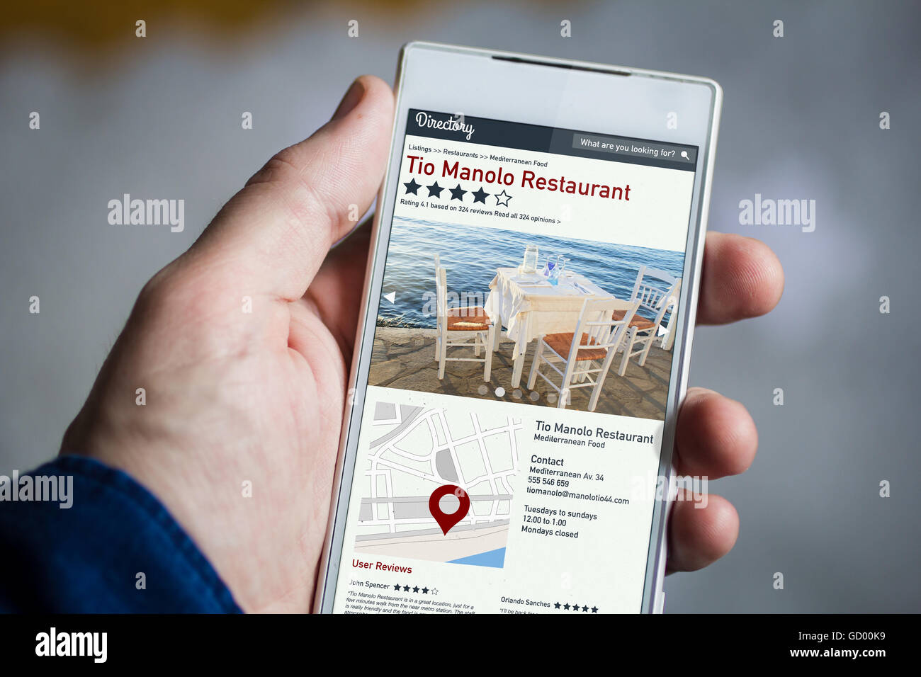 man hand holding directory online smartphone. All screen graphics are ...