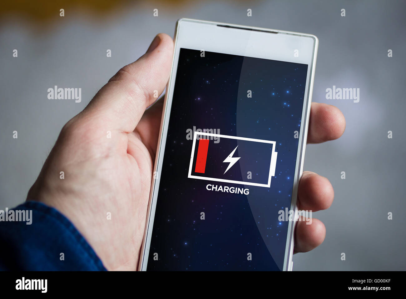 man hand holding charging smartphone. All screen graphics are made up ...