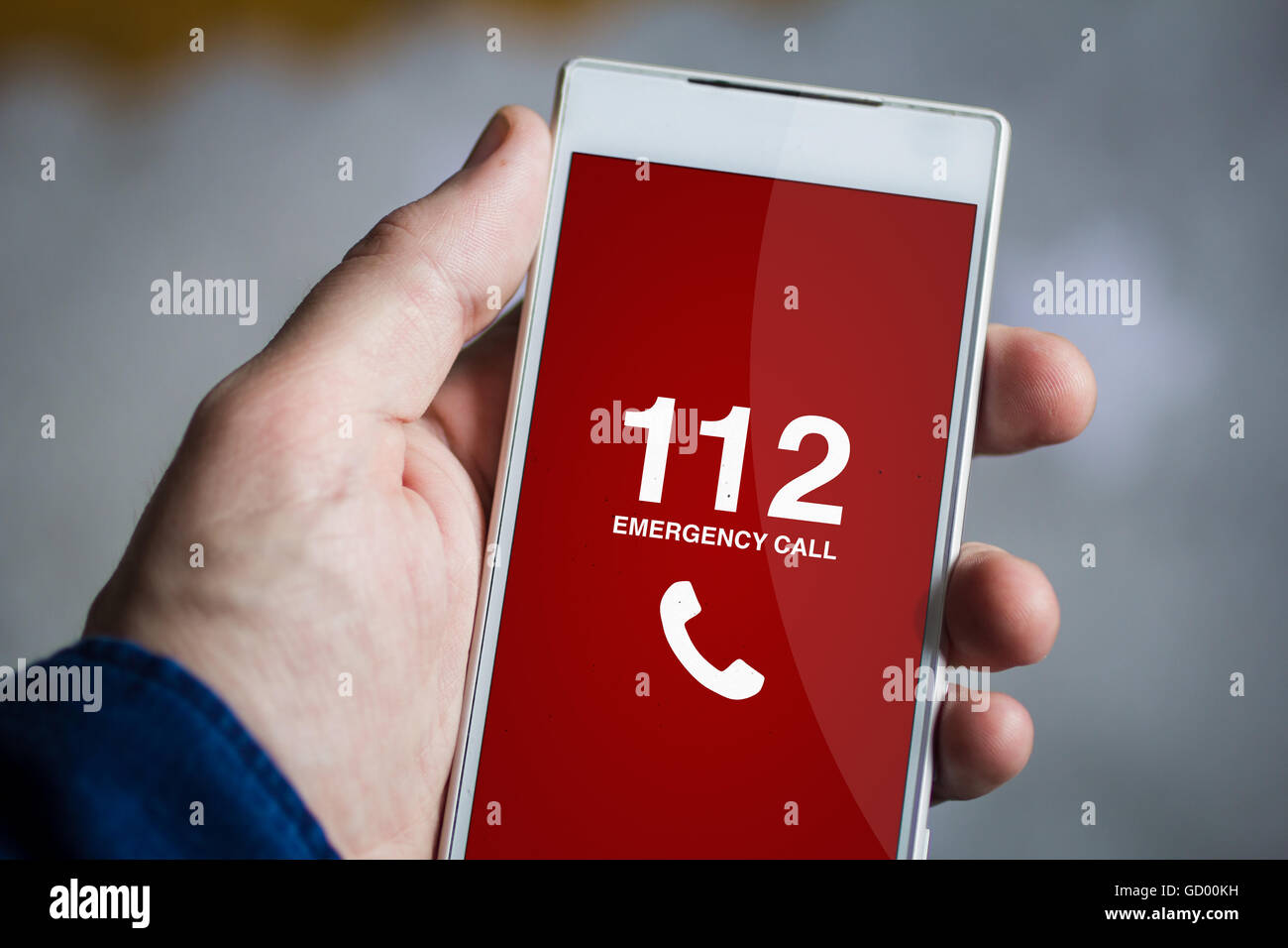 man hand holding emergency call smartphone. All screen graphics are ...