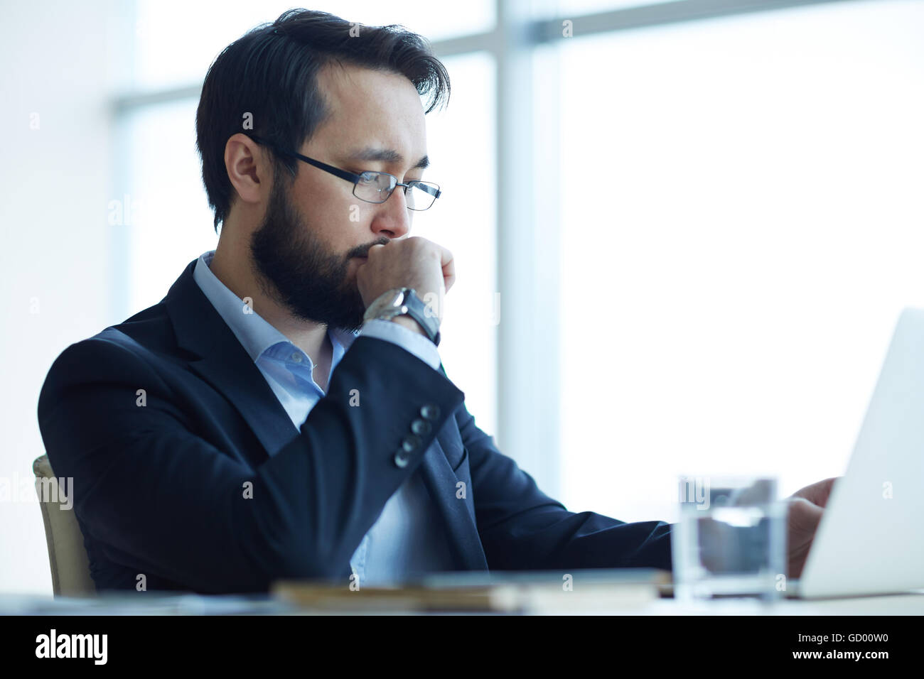 Pensive asian young man working hi-res stock photography and images - Alamy