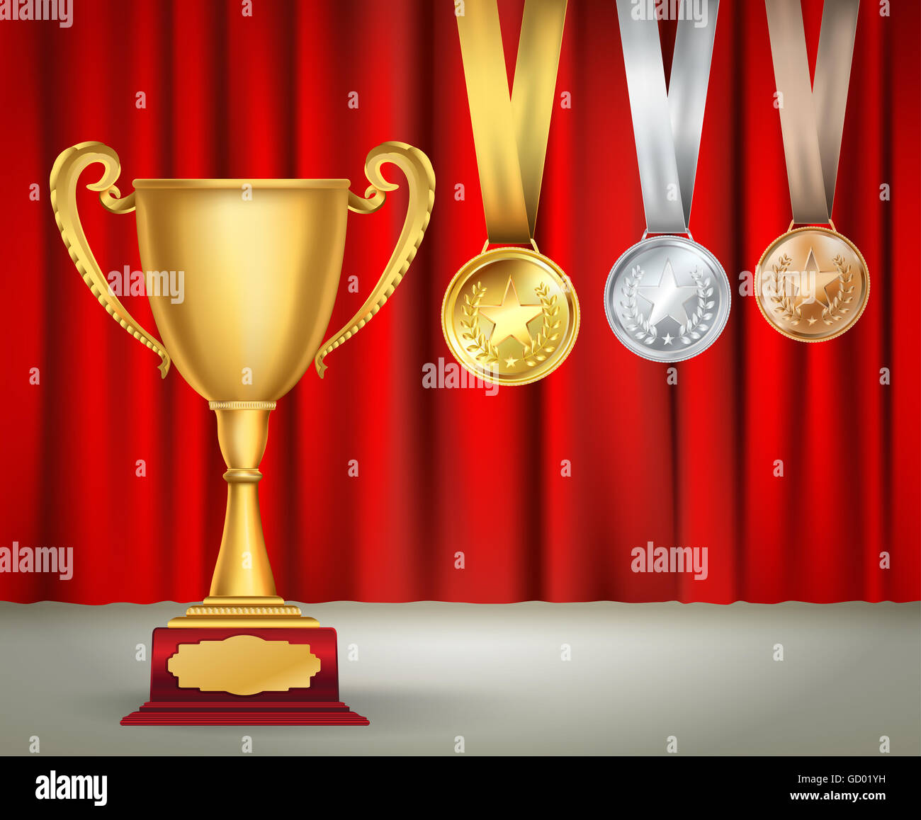 golden trophy cup and set of medals with ribbons on red curtain ...