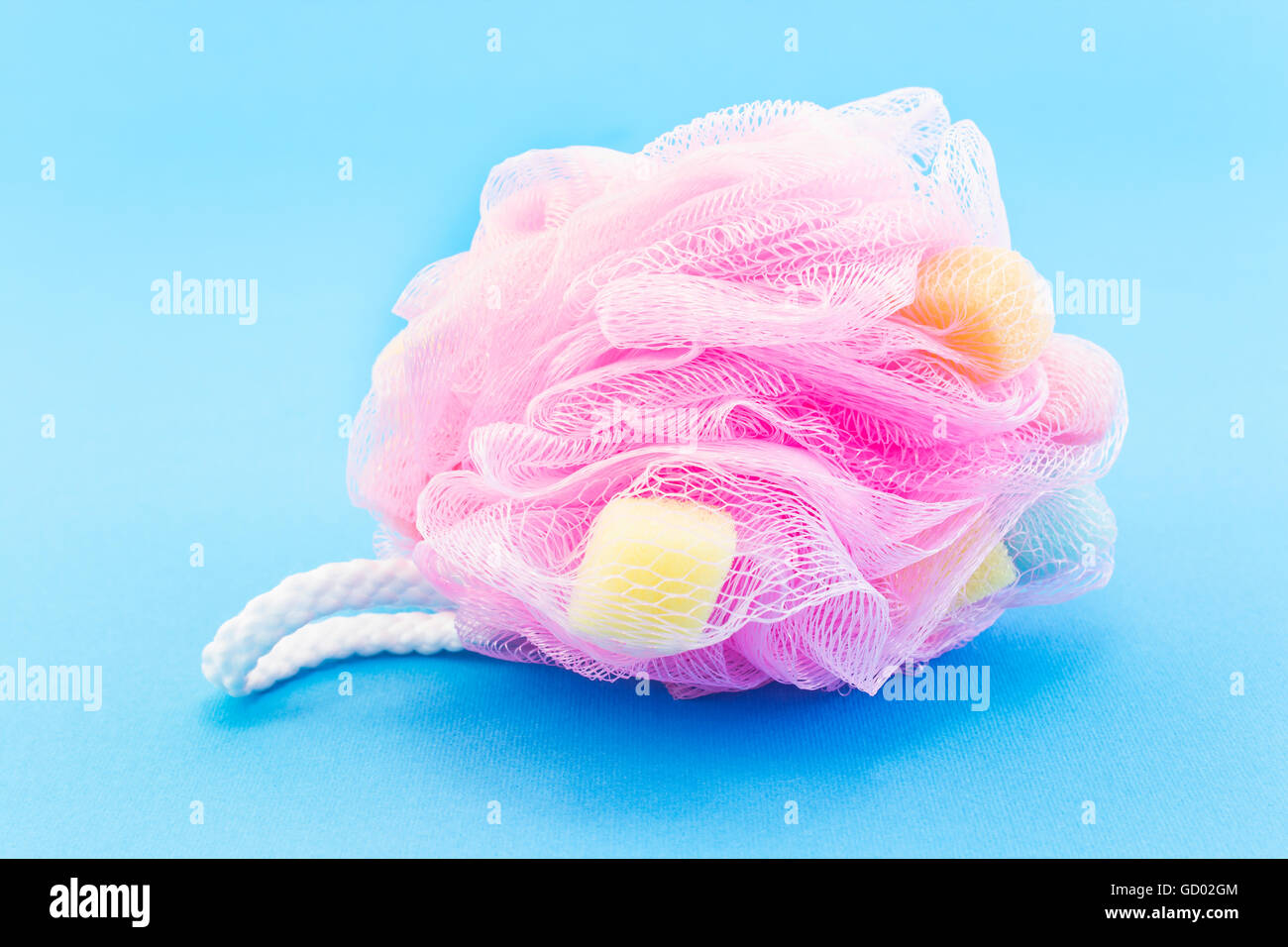 Pink Bath Puff Isolated on Blue Stock Photo - Alamy