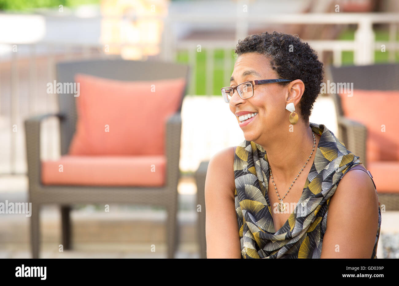 Closeup portrait, mature woman with glasses sitting and smiling ...