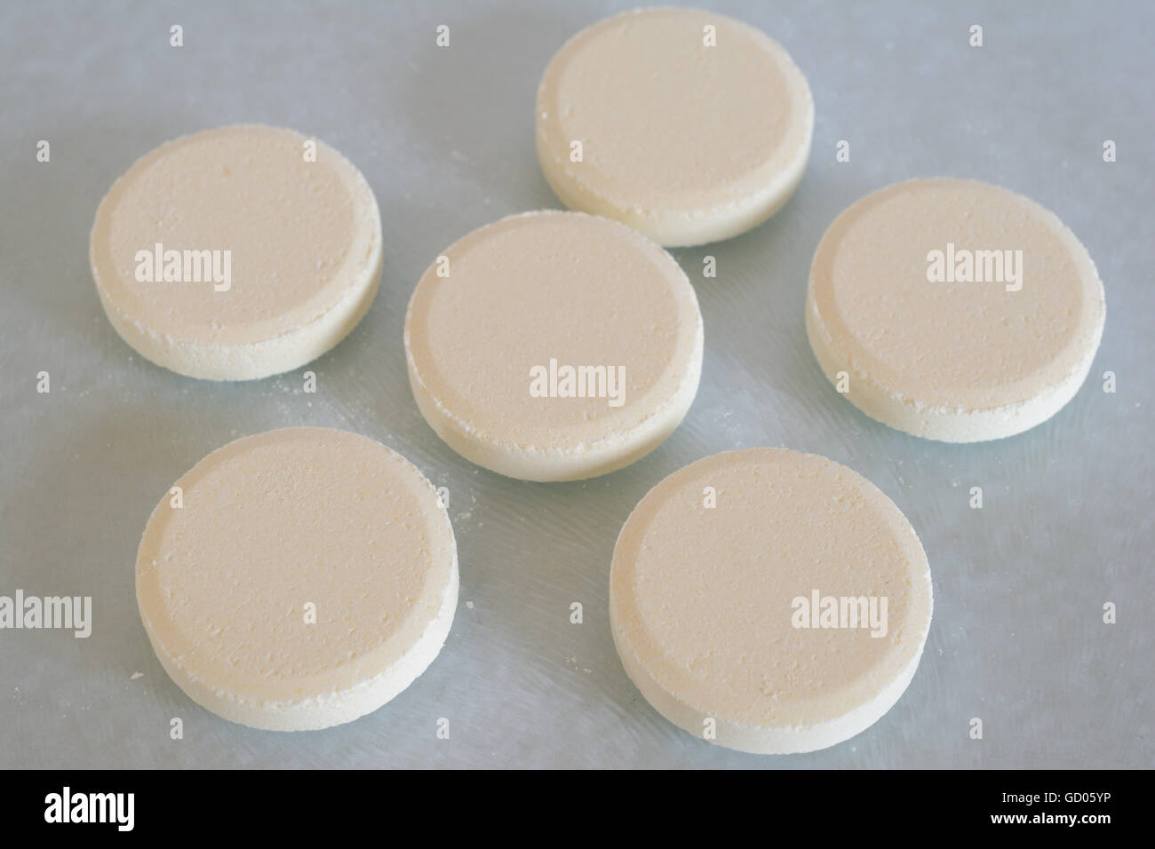 Soluble tablets on glass table top closeup Stock Photo - Alamy