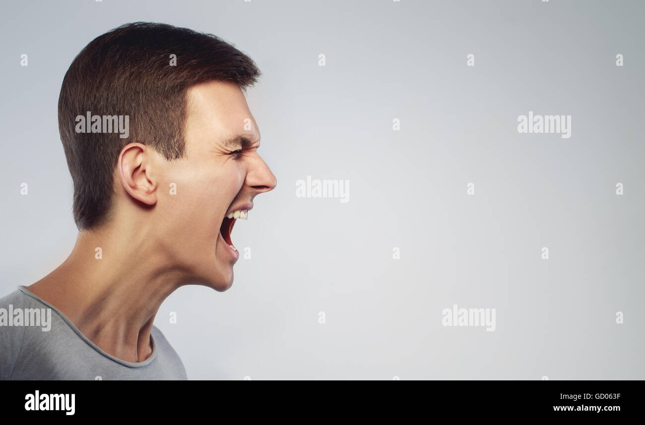 Close up face of man shouting with anger. Cry and stand in profile ...